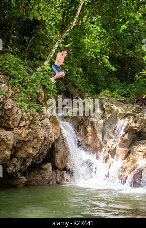 men jumping in a waterfall Stock Photo - Alamy
