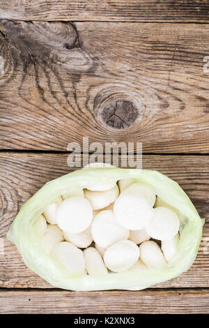 Different ingredients of a cookie in white bowls put on a wooden ...