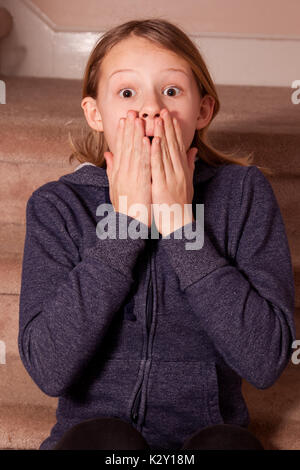 Horrified young woman covering her eyes to avoid seeing something ...