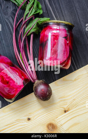 Canned homemade beetroot in clear glass jars with fresh organic ...