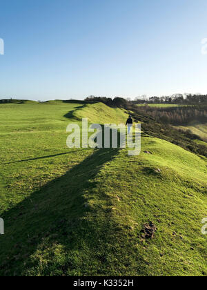 Low sunlight highlights embankment earthworks on Iron Age Hill Fort ...