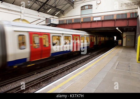 District Line train at Fulham Broadway Underground station in London ...