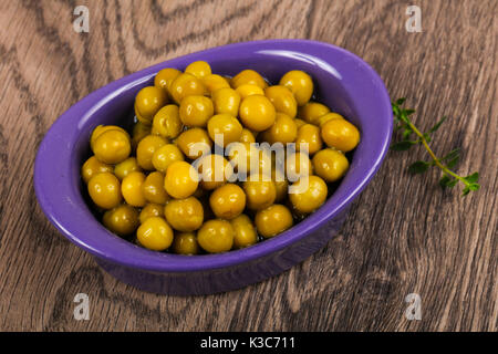 Pickled pea in the plate over wooden background Stock Photo - Alamy