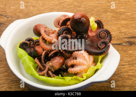 Boiled baby octopuses over salad leaves Stock Photo - Alamy