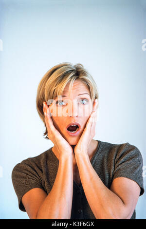 Portrait of woman with look of surprise Stock Photo - Alamy