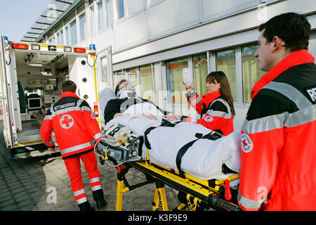 Cardiac patient in an ambulance. Paramedic performing an ...