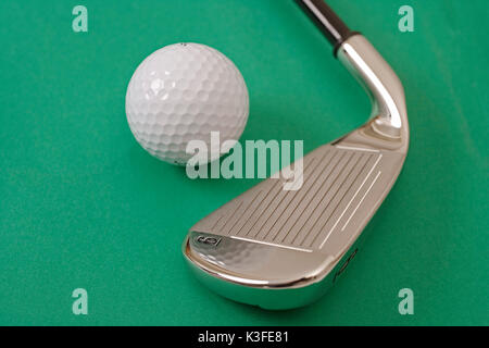 Golf ball and iron racquet Stock Photo - Alamy
