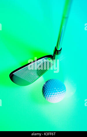 Golf ball and iron racquet Stock Photo - Alamy