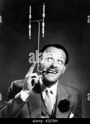 Actor Terry Thomas smoking a cigarette May 1959 Stock Photo - Alamy