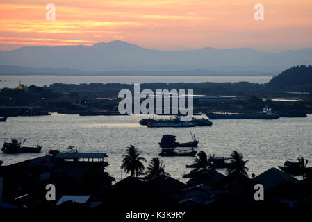 the sunset at the Harbour at the coast of the Andaman sea of Myeik in ...