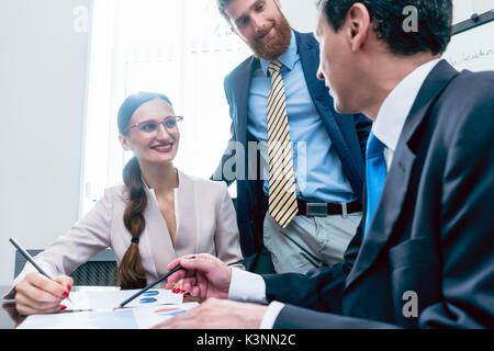 Business analyst smiling while interpreting financial reports showing ...