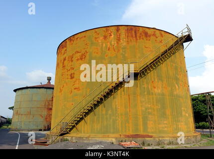 A large rusting storage tank at a vintage industrial facility Stock ...