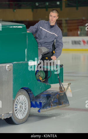 cleaning clearing ice rink tractor hopper crisp Stock Photo - Alamy