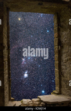 The Orion constellation visible through an old ancient stone window ...