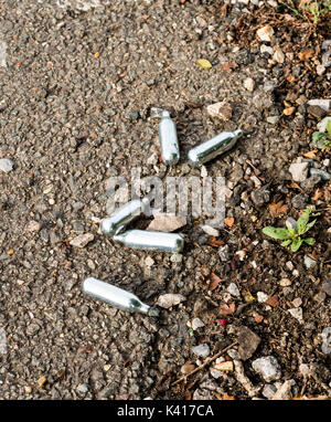 Nitrous Oxide whippits on urban street Stock Photo - Alamy
