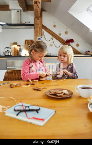 Two girls cozy at home while crafting, portrait Stock Photo - Alamy