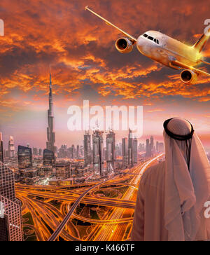 Arabian man with airplane flying over Dubai against colorful sunset in ...