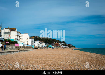 On Sandgate beach near Folkestone, UK, a caterpillar bulldozer moves ...