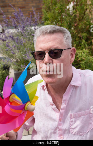 Young at Heart Senior Man with Colorful Pinwheel Toy Stock Photo - Alamy