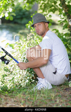 Portrait of angry fisherman Stock Photo - Alamy