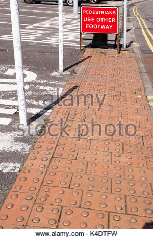 Tactile paving at the crossing point of a road to help visually Stock ...