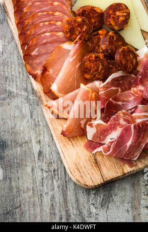 Spanish cold cuts (embutidos). Cheese, sausage and ham on gray stone ...