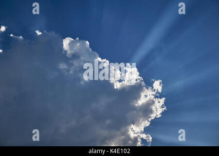 Beautiful skyscape with sun rays behind the clouds Stock Photo - Alamy