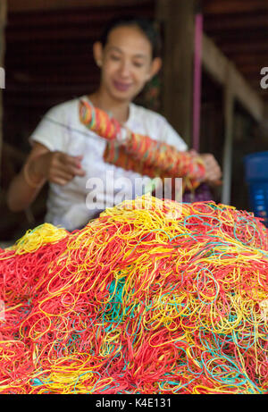 Rubber band factory, Mon State, Myanmar. Women operating guillotining ...