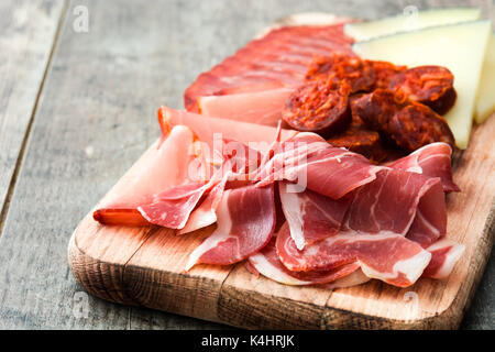 Spanish cold cuts (embutidos). Cheese, sausage and ham on wooden table ...