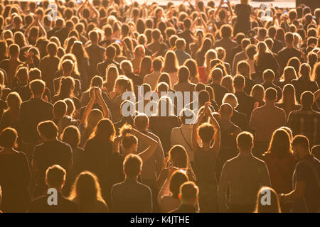 Anonymous crowd of people standing during mass event Stock Photo - Alamy