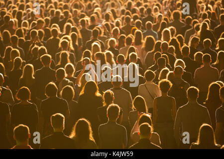 Anonymous crowd of people standing during mass event Stock Photo - Alamy