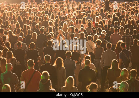 Anonymous crowd of people standing during mass event Stock Photo - Alamy