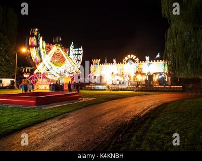 Fair, attraction, pendulum, scary castle, night Stock Photo - Alamy