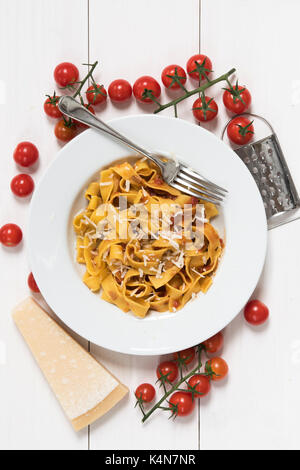 Tagliatelle bolognese plate with grated Parmesan cheese view from top ...