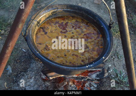 Juicy bubbling stew in a large pot cooking outdoors Stock Photo - Alamy