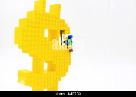 The concept of the path to wealth. The figurine of the man goes to the ...