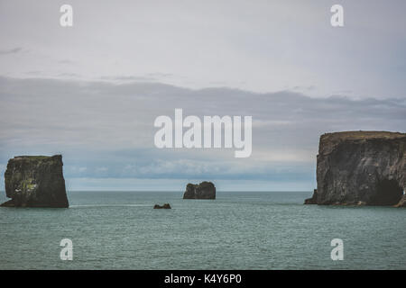 Rocks formation on Dyrholaey cape with black sand beach near Vik Stock ...