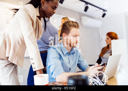 Busiensswoman advising colleague Stock Photo - Alamy