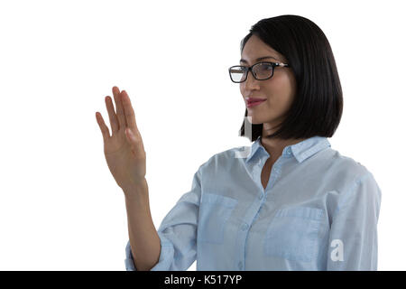 Woman using invisible screen against black background Stock Photo - Alamy
