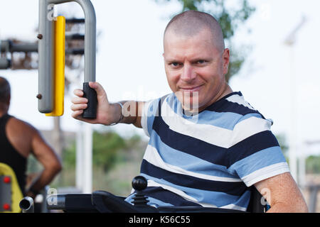 Disabled man working out with trainer Stock Photo - Alamy