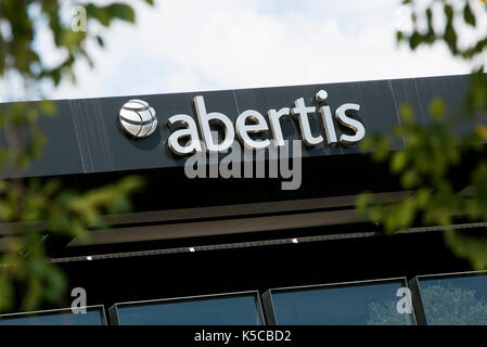 A logo sign outside of the headquarters of Abertis Infraestructuras in ...