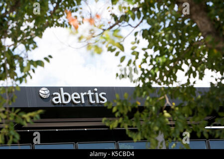 A logo sign outside of the headquarters of Abertis Infraestructuras in ...
