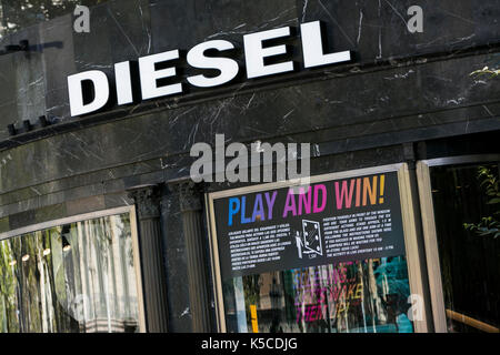 A logo sign outside of a Diesel clothing retail store in Barcelona ...