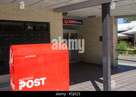 A red australia post letter box stripped of all branding and logos ...