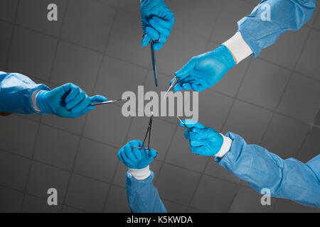 Close-up of of surgeons hands at work in operating theater toned in ...