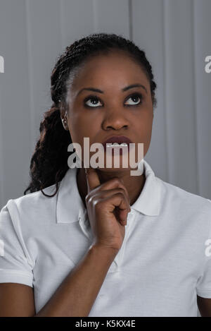 Beautiful woman in black t-shirt and red skirt and glasses walking in ...