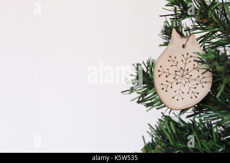 Handmade pyrography snowflake ornament on a Christmas tree with white ...