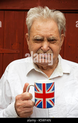 87 year old elderly man, living alone, stood in his hallway, England ...