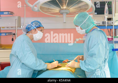 two surgeons working on patient Stock Photo - Alamy
