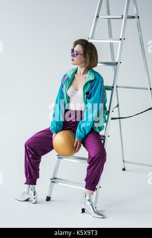 stylish woman leaning on ladder Stock Photo - Alamy